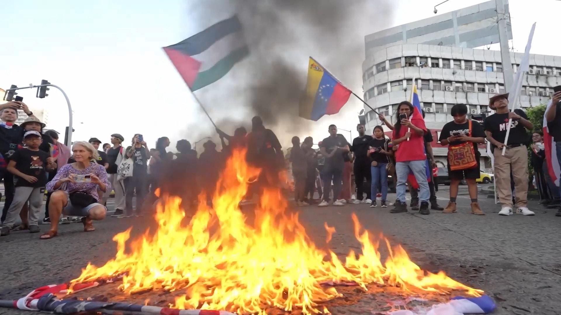 'Wars do not solve anything' - Activists burn US flag outside American ...