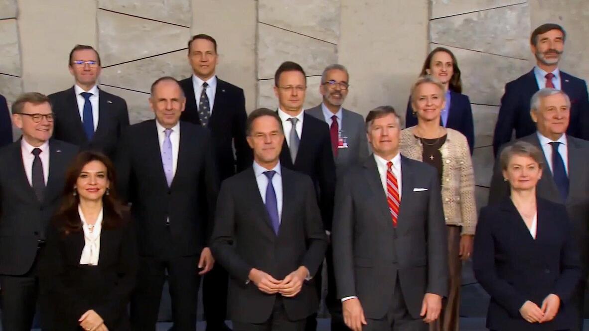 Smile, it's not the end of the world! - NATO FMs grin through family ...