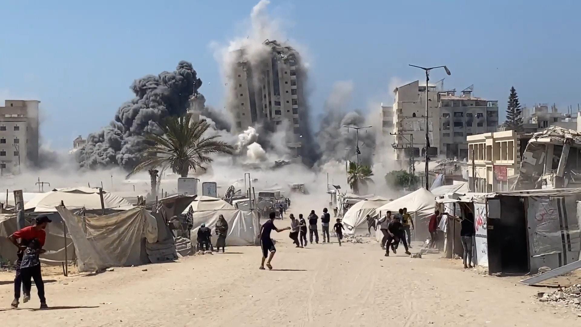 Direct hit - Strike levels Gaza high-rise as Israel vows to 'open gates ...