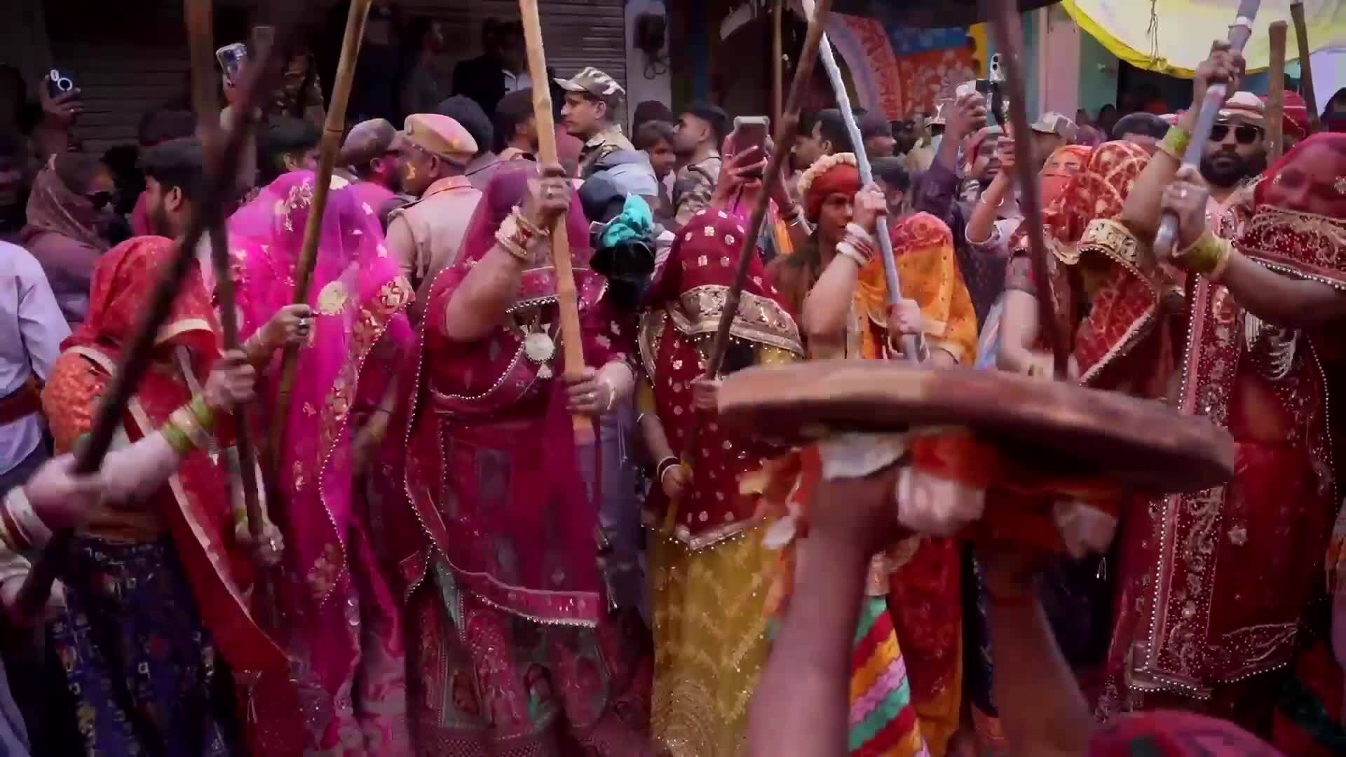 Whack-a-man! Thousands of women wield wooden sticks in playful battle ...